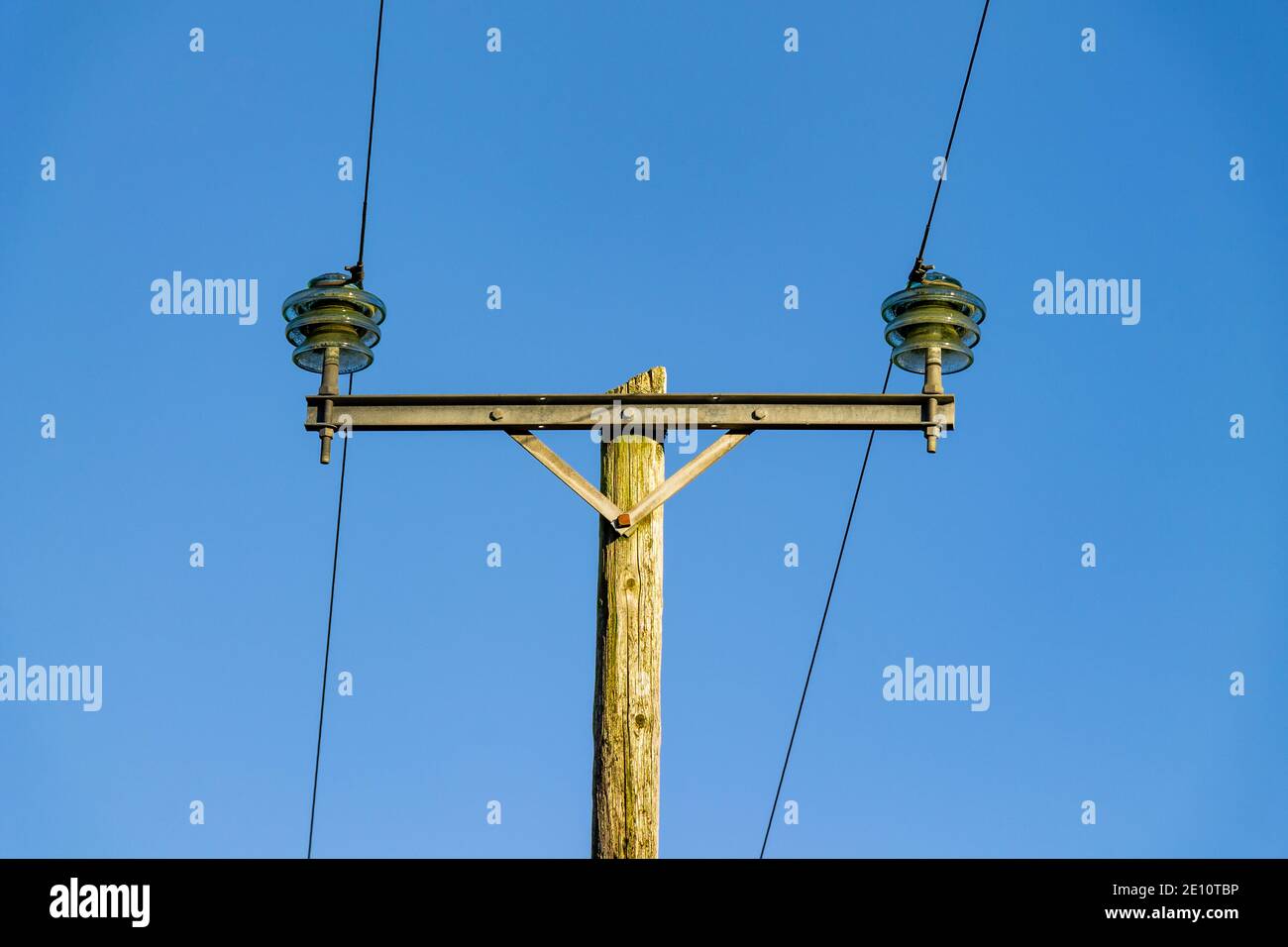 Electrical Power lines in silhouette against blue sky Stock Photo - Alamy