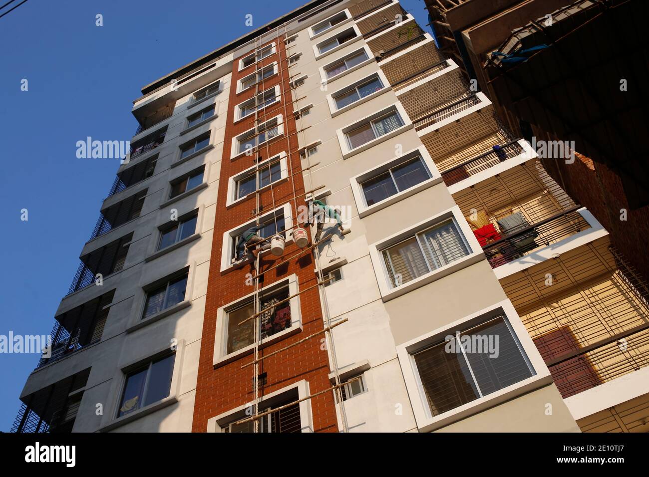Dhaka, Bangladesh. 3rd Jan, 2021. Workers paint the exterior wall of a ...