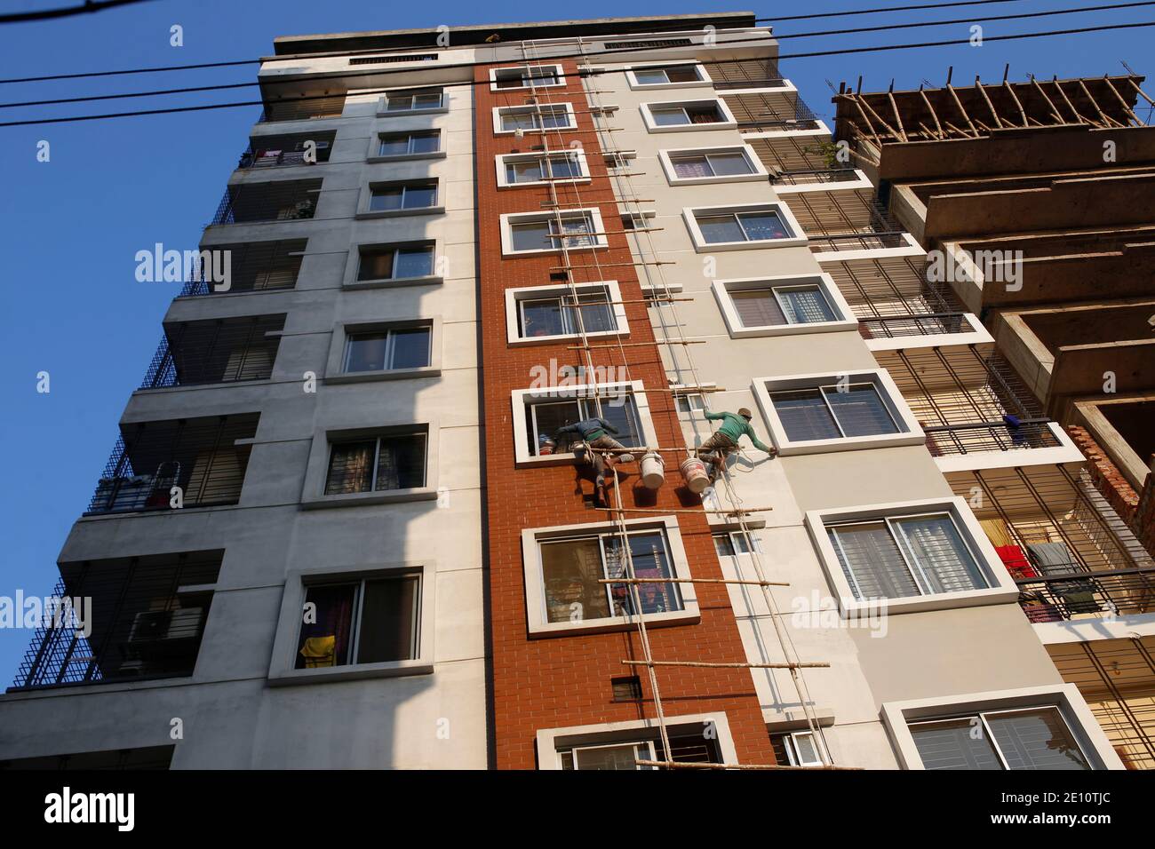 Dhaka, Bangladesh. 3rd Jan, 2021. Workers paint the exterior wall of a ...