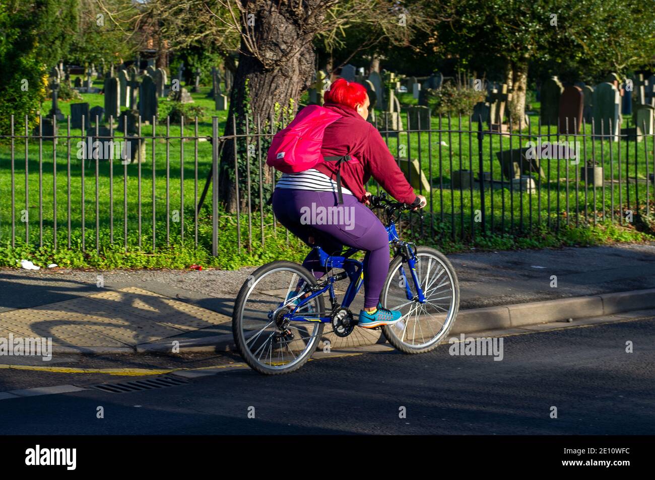 Slough, Berkshire, UK. 3rd January, 2021. An overweight woman rides her ...