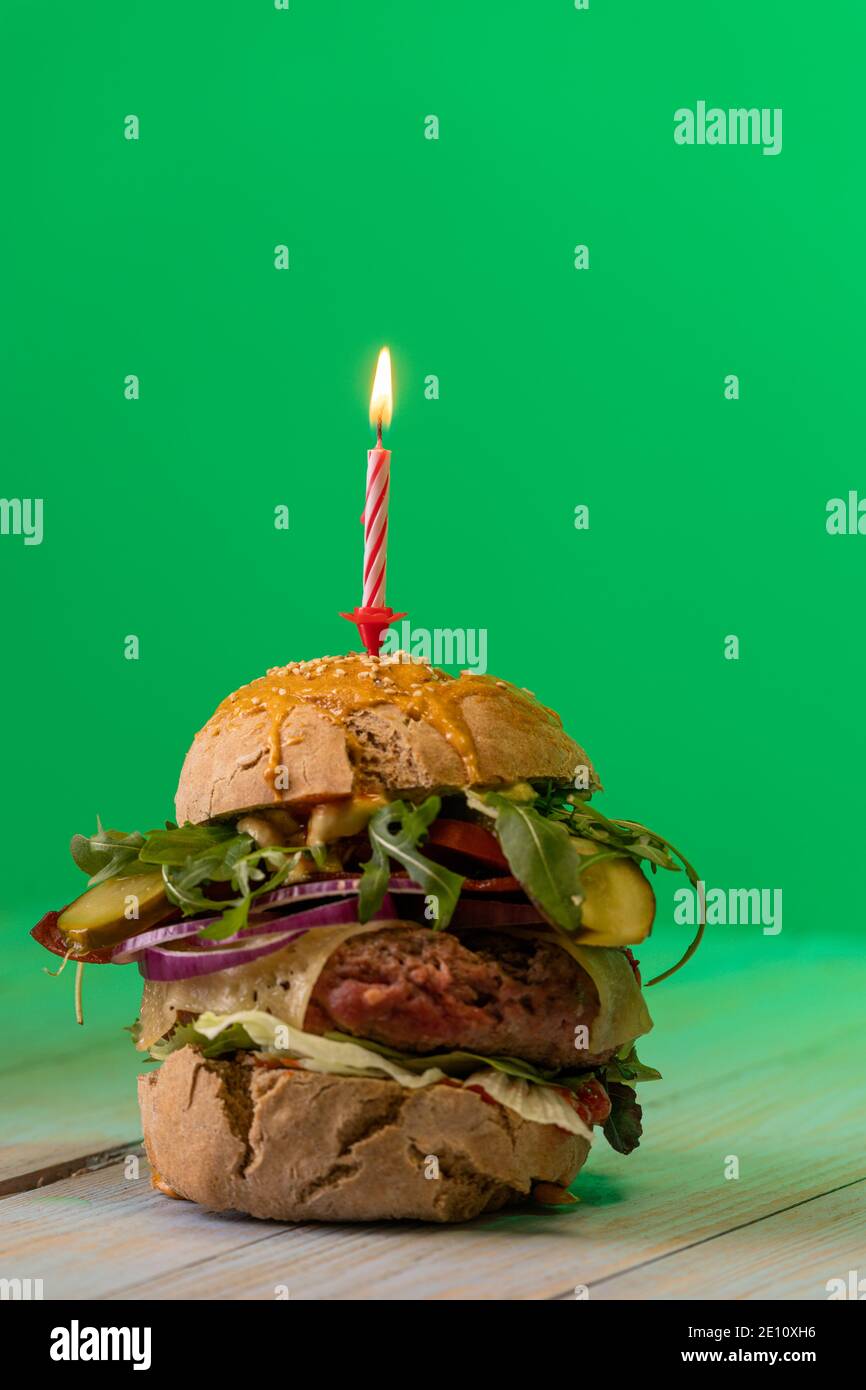 Cheeseburger With A Candle Stock Photo - Alamy
