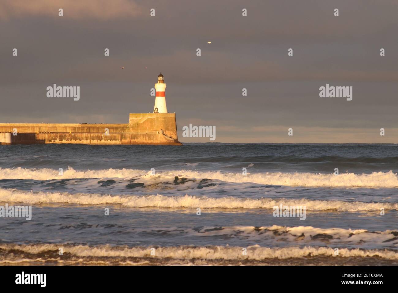 Red and white beacon on pier Stock Photo - Alamy