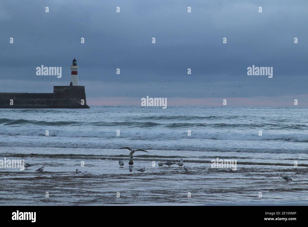 Red and white beacon on pier Stock Photo - Alamy