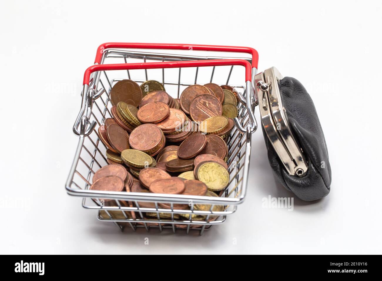 Iron shopping basket filled with euro coins isolated on white ...