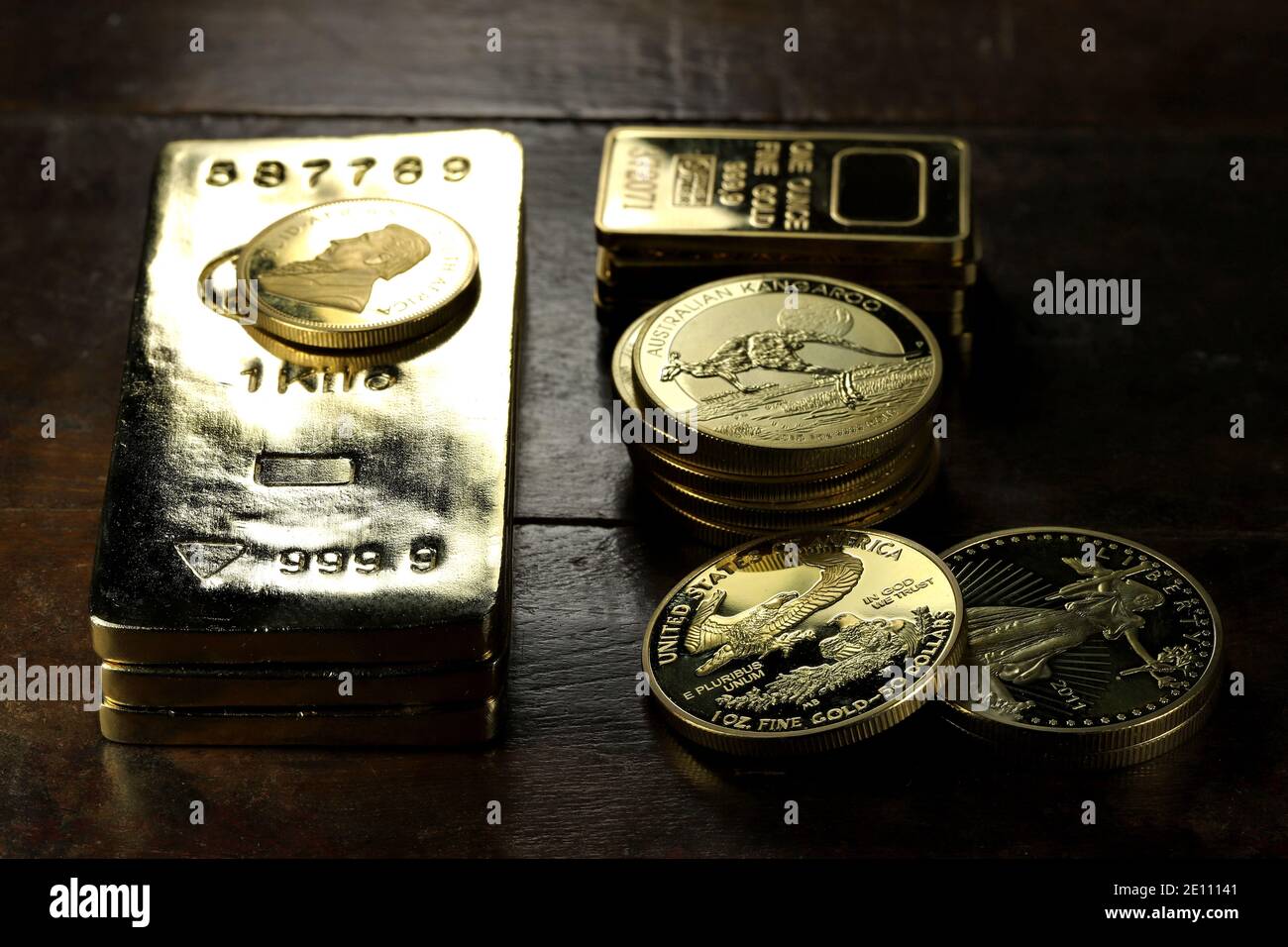 gold ingots an various bullion coins on wooden background Stock Photo ...