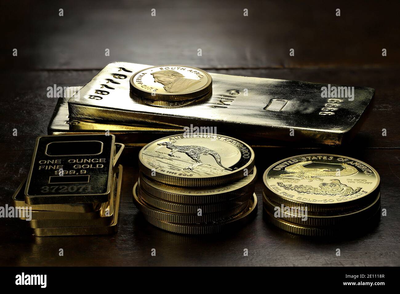 gold ingots an various bullion coins on wooden background Stock Photo ...