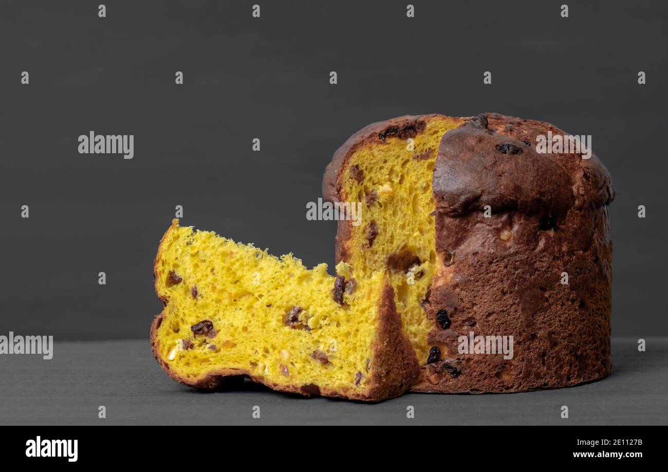 Easter panetone italian with a cut off piece on the gray background ...