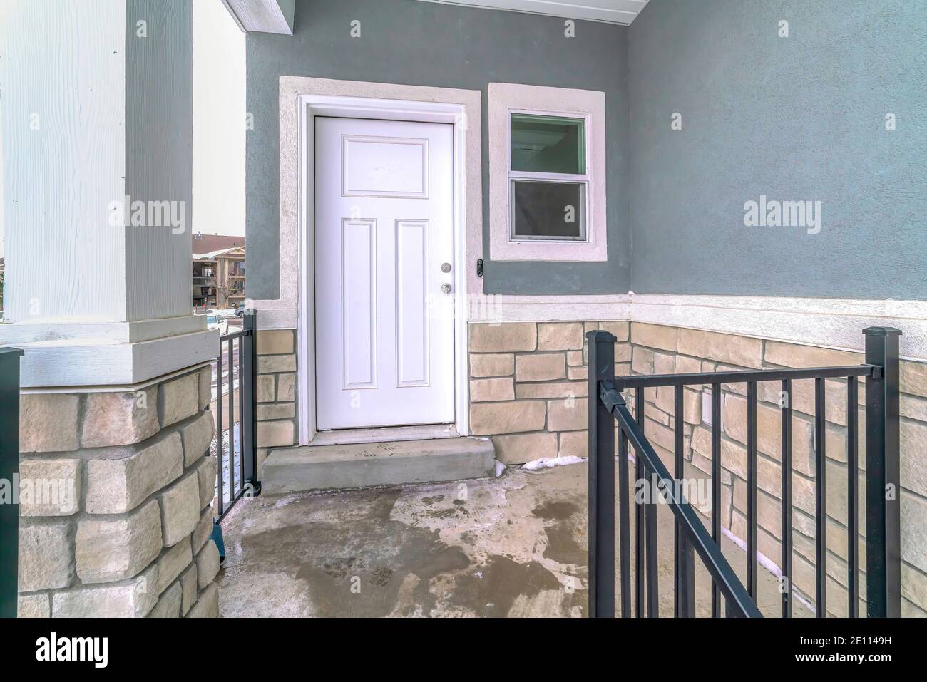 Wooden white panelled hinged front door and small sliding window at ...