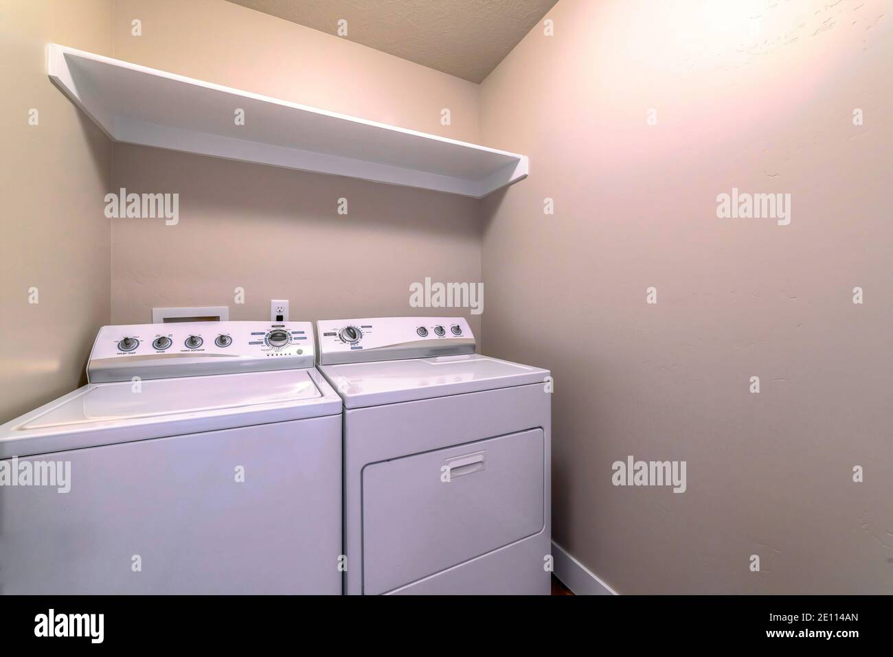 Home appliances for washing and drying clothes inside the laundry room ...