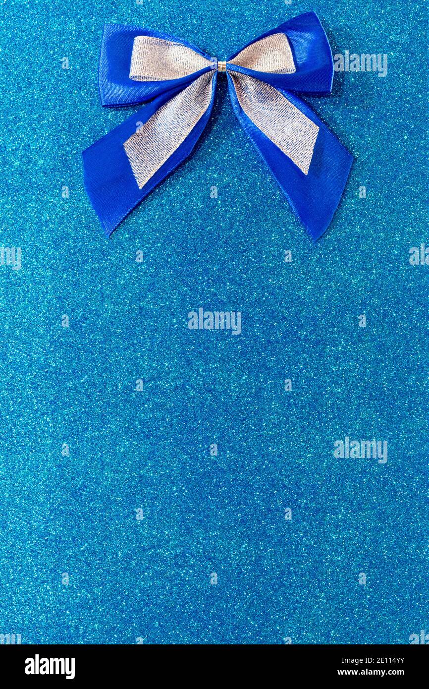 Blue and silver bow on shiny background for text. Copy space Stock ...