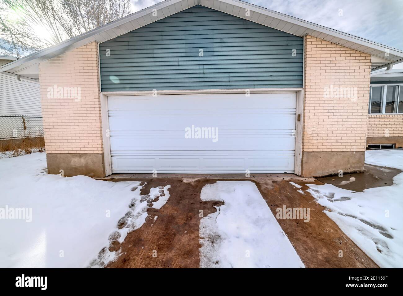 Front view of garage building with gable roof white door and brick ...