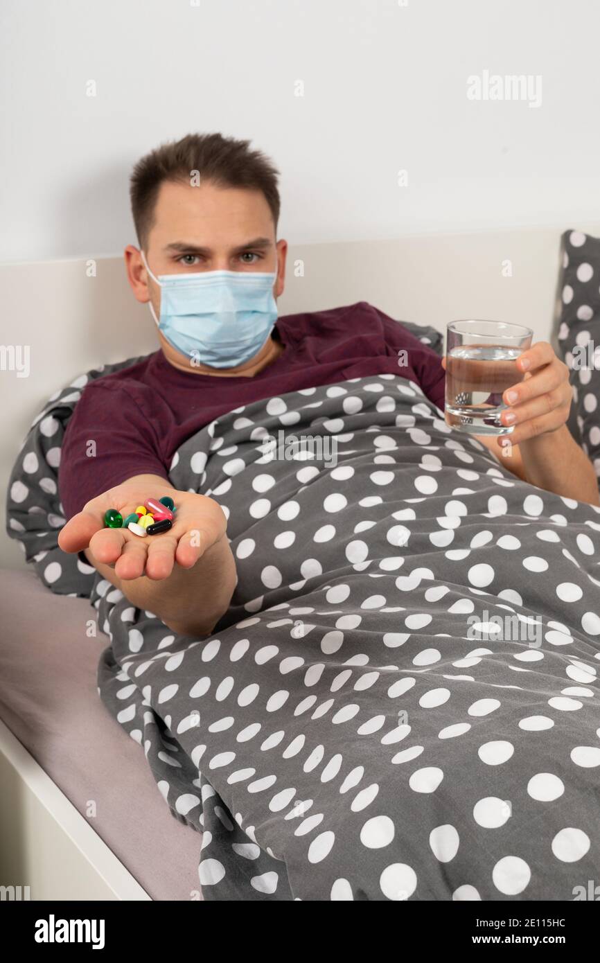 Picture of caucasian young man infected with covid-19 staying in bed at ...