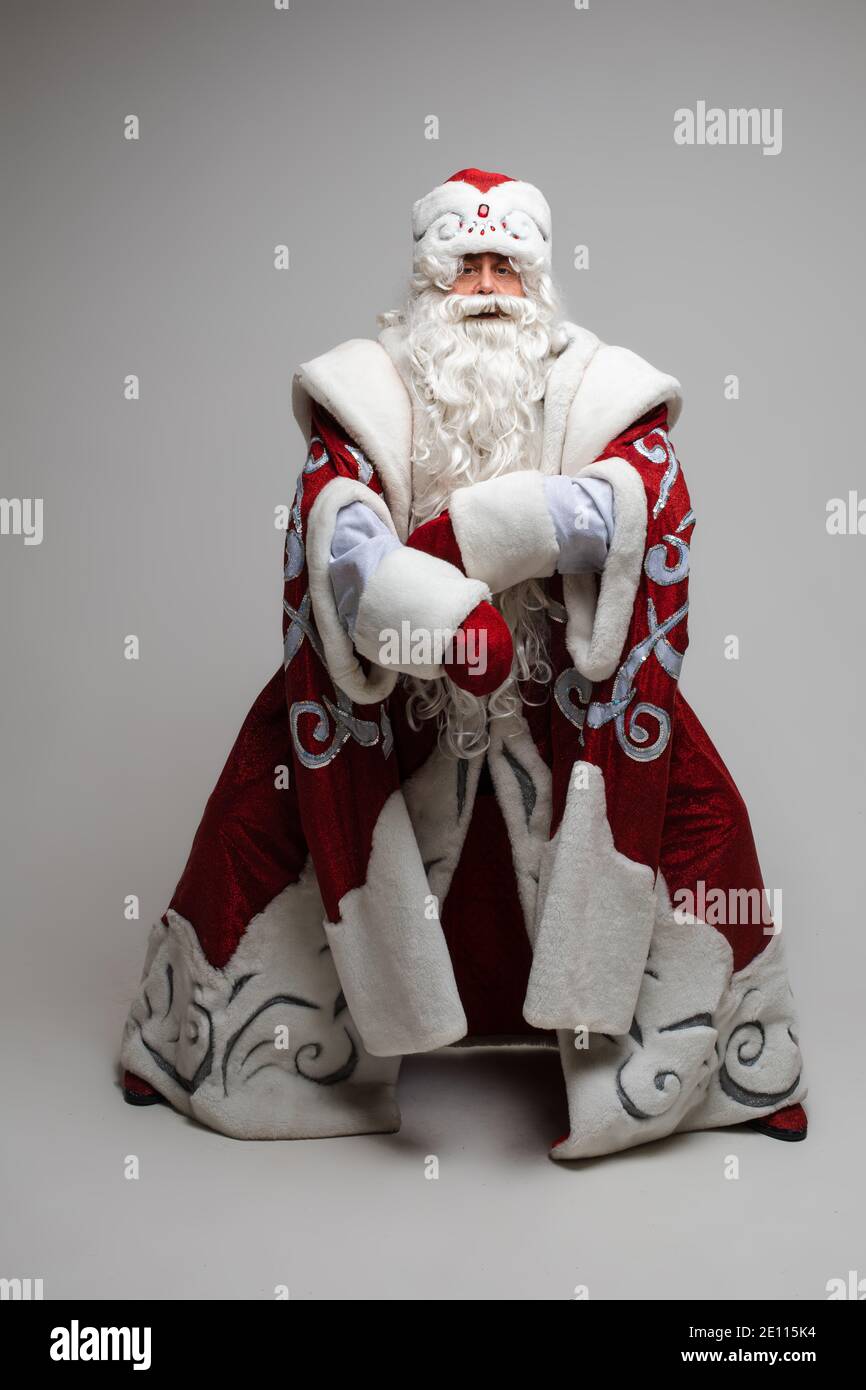 Cool gray haired with long beard Santa Claus in red clothes posing on ...