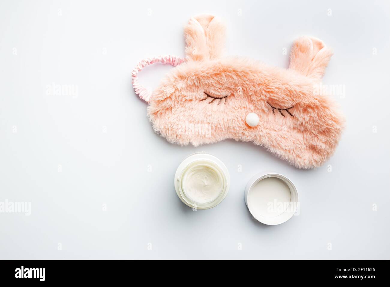 Cosmetic white containers with sleeping mask on white background top ...