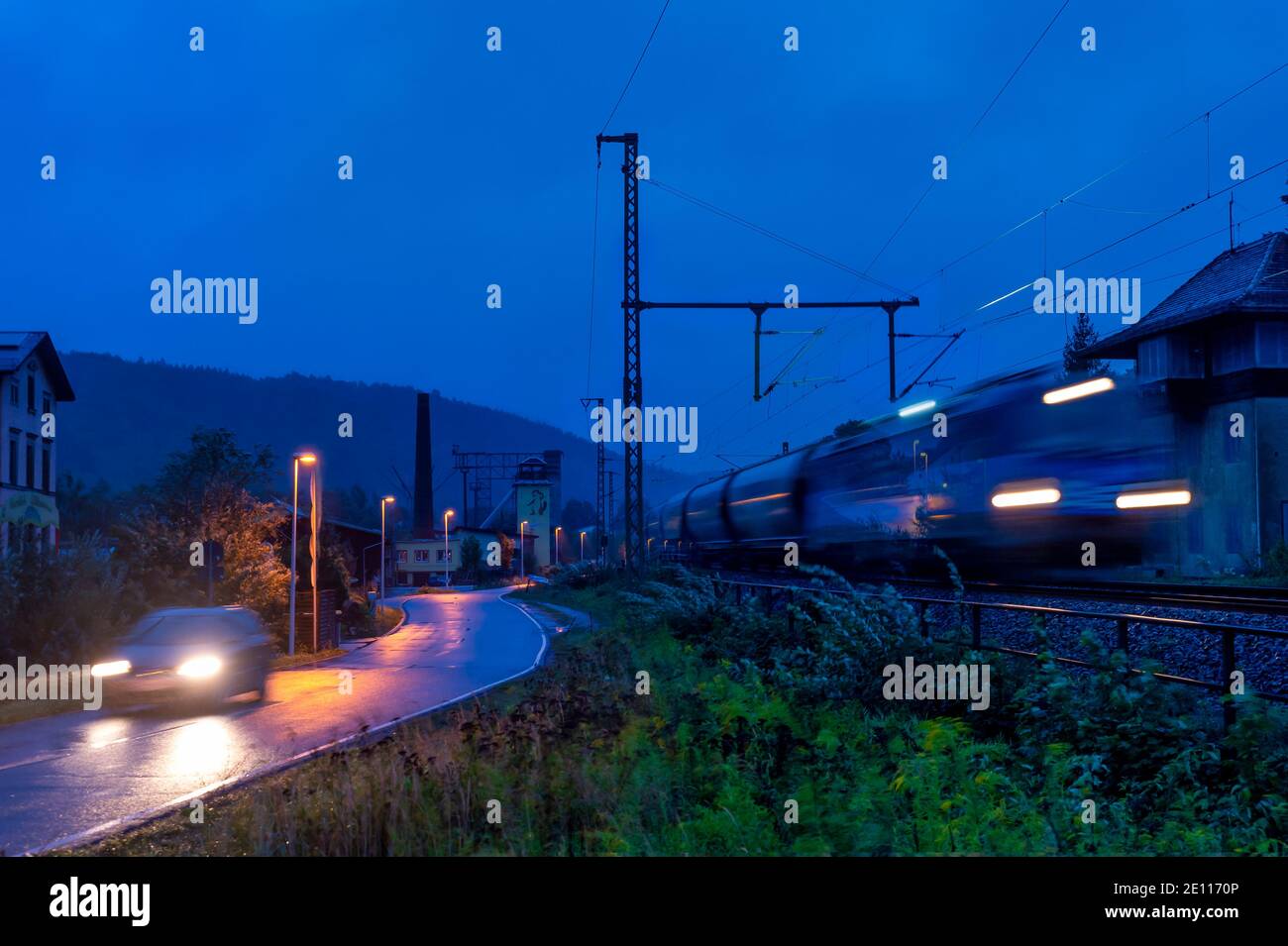 Freight Train And Car At Night Next To Each Other Stock Photo - Alamy