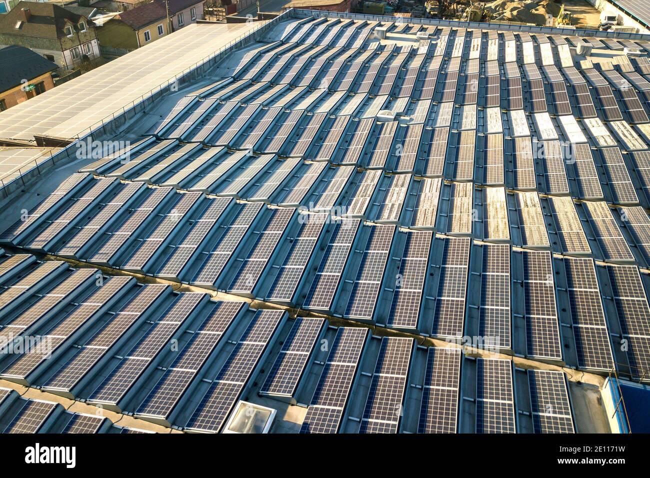 Aerial view of many photo voltaic solar panels mounted of industrial ...