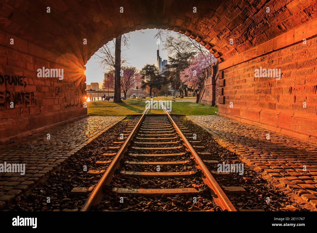 Sunset on the river Main. Red brick tunnel with an old railroad track ...