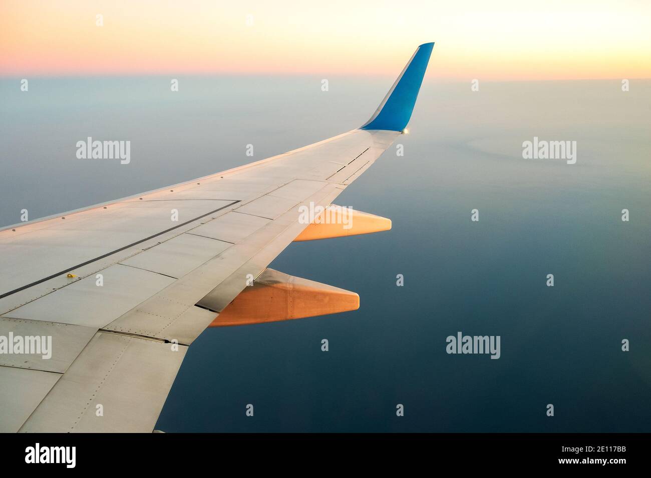 View from airplane on the aircraft white wing flying over ocean ...
