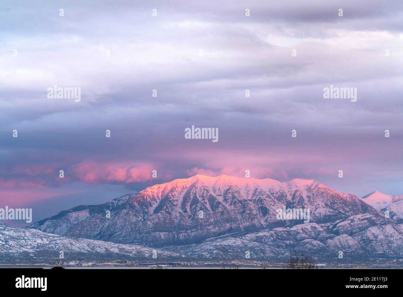 Foggy landscape of majestic snowy mountain in winter with sunlit peak ...