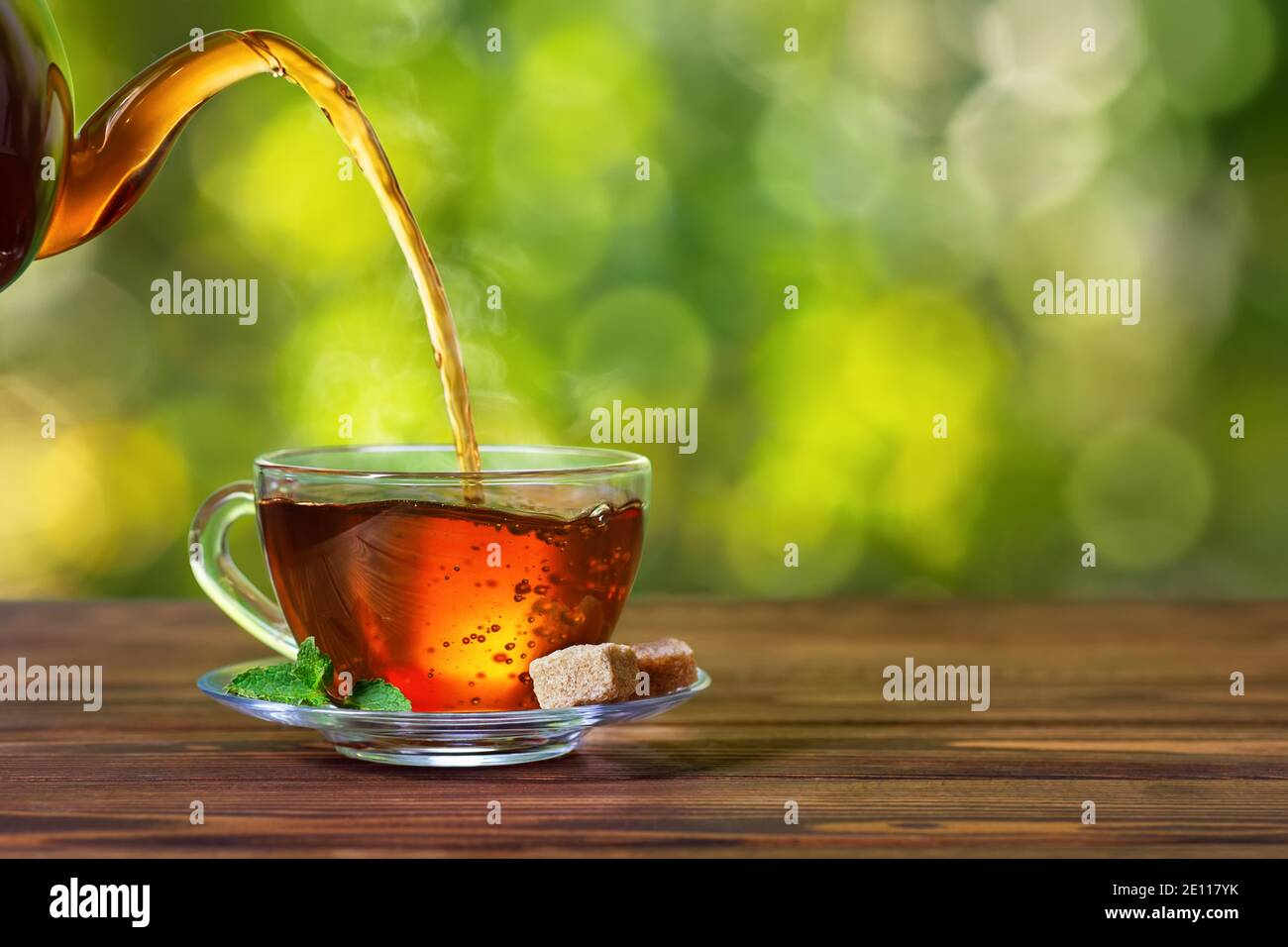 tea pouring from teapot into cup Stock Photo - Alamy