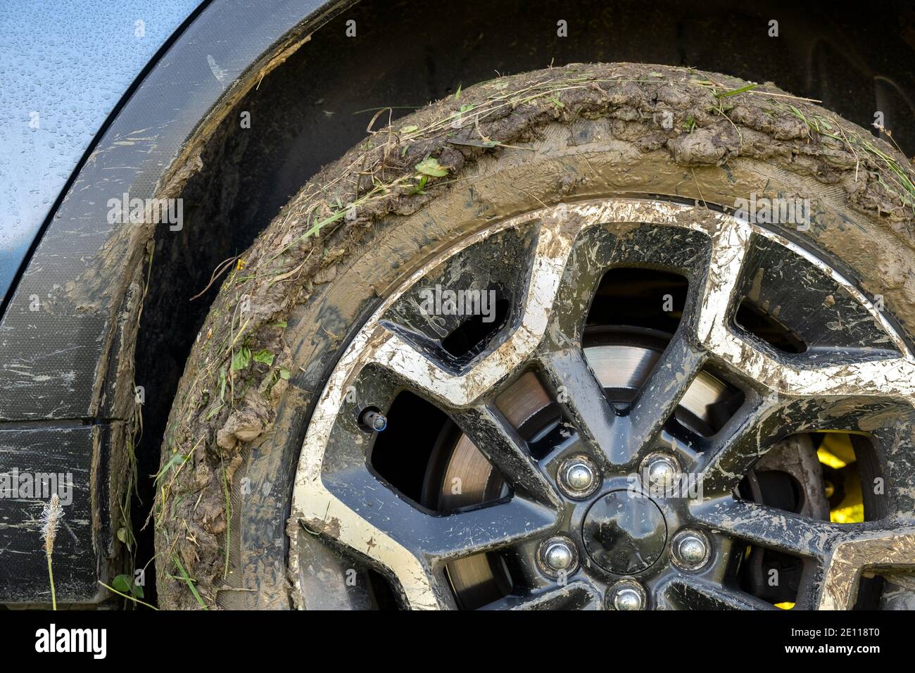 Close up of dirty off road car wheels with dirty tires covered with ...