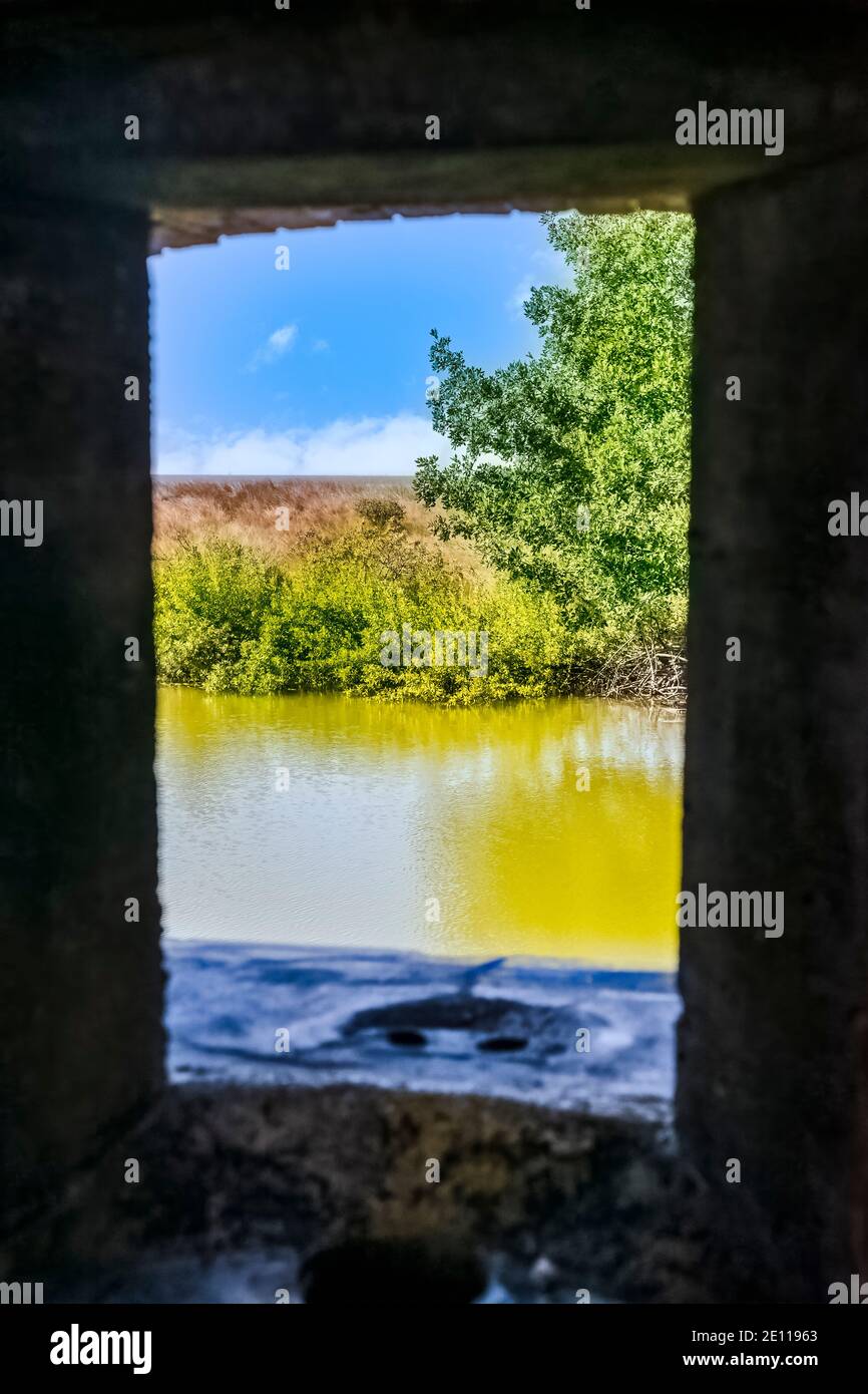 Looking out a gun port of the Civil War Fort Zachary Taylor to the ...