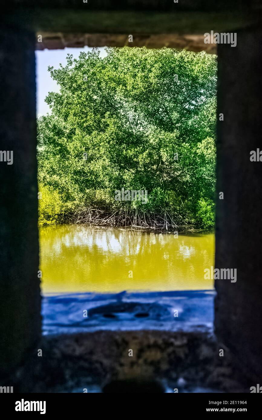 Looking out a gun port of the Civil War Fort Zachary Taylor to the ...