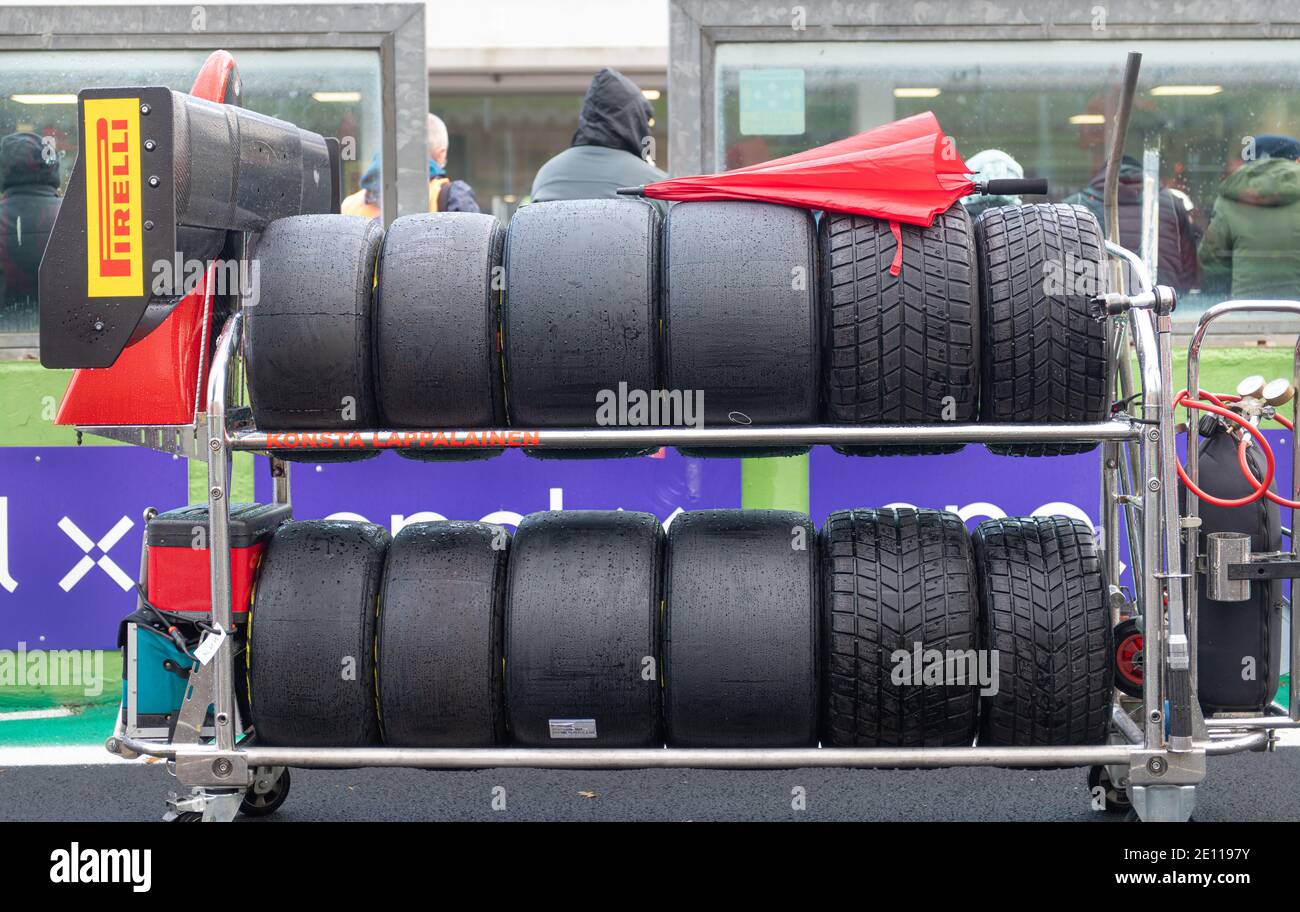 Racing car team cart on starting grid with Pirelli set tires and nose ...