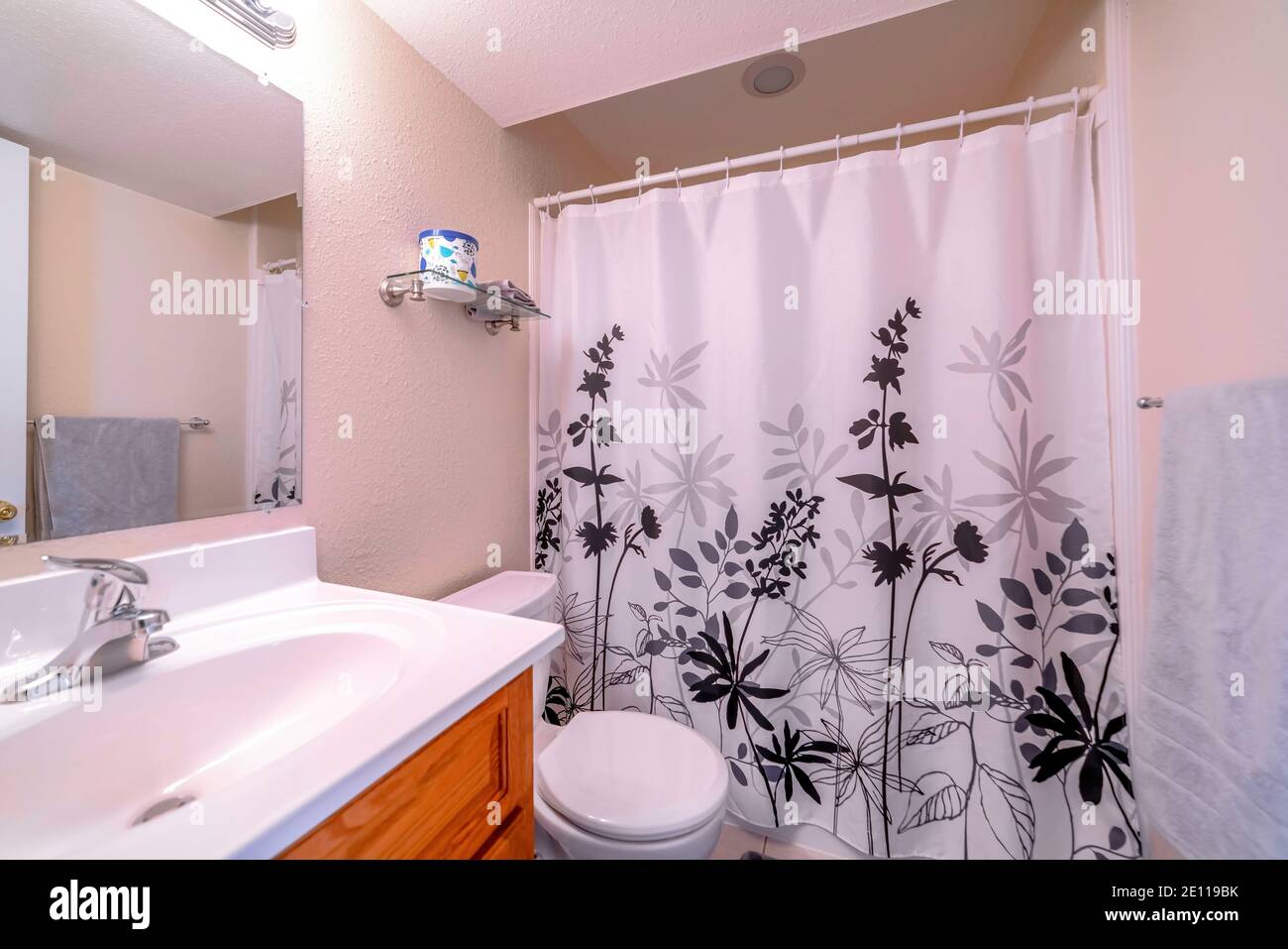 Interior of small bathroom with printed curtain on the bathtub and ...
