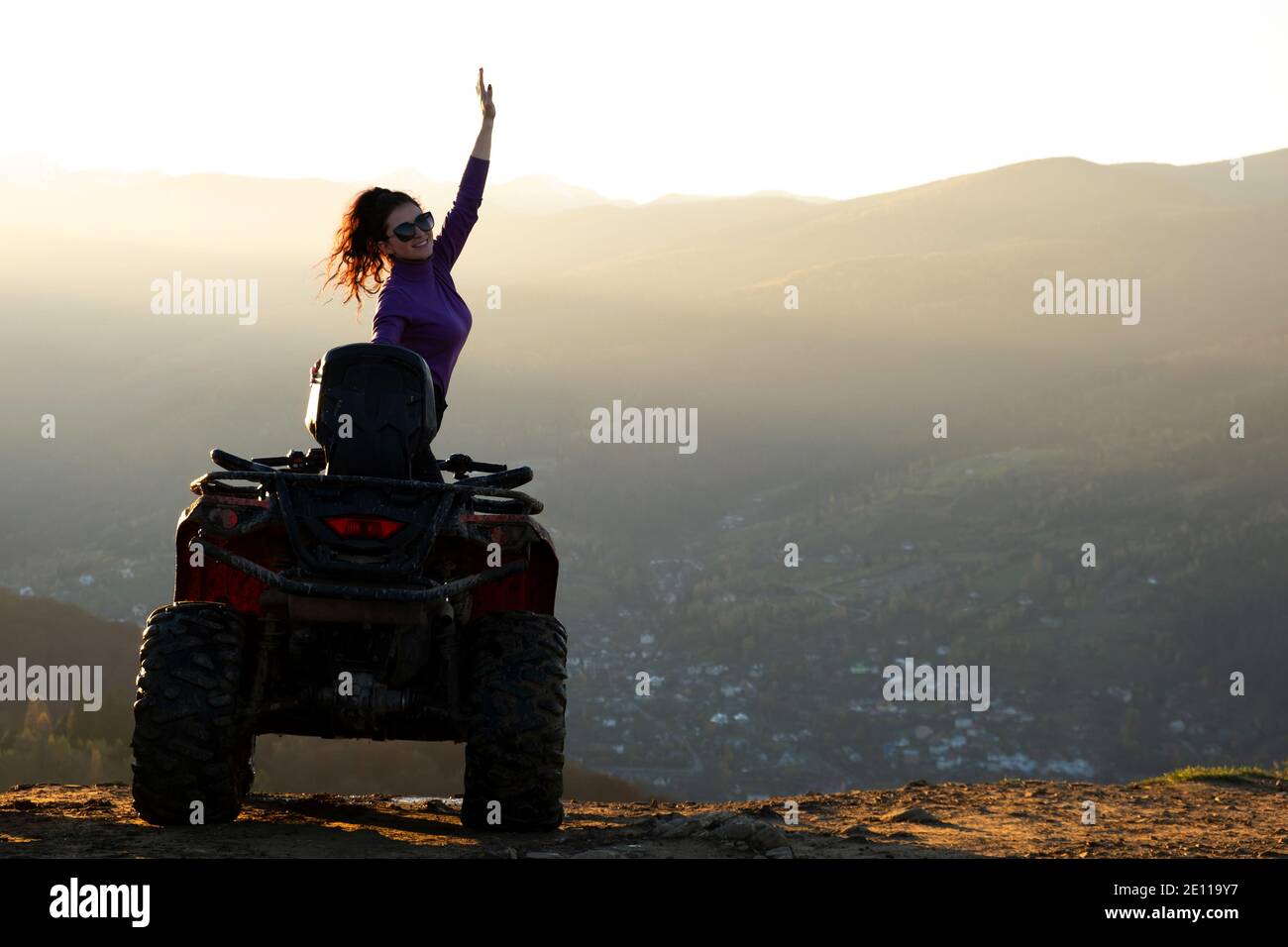 Happy active female driver enjoying extreme riding on ATV quad ...