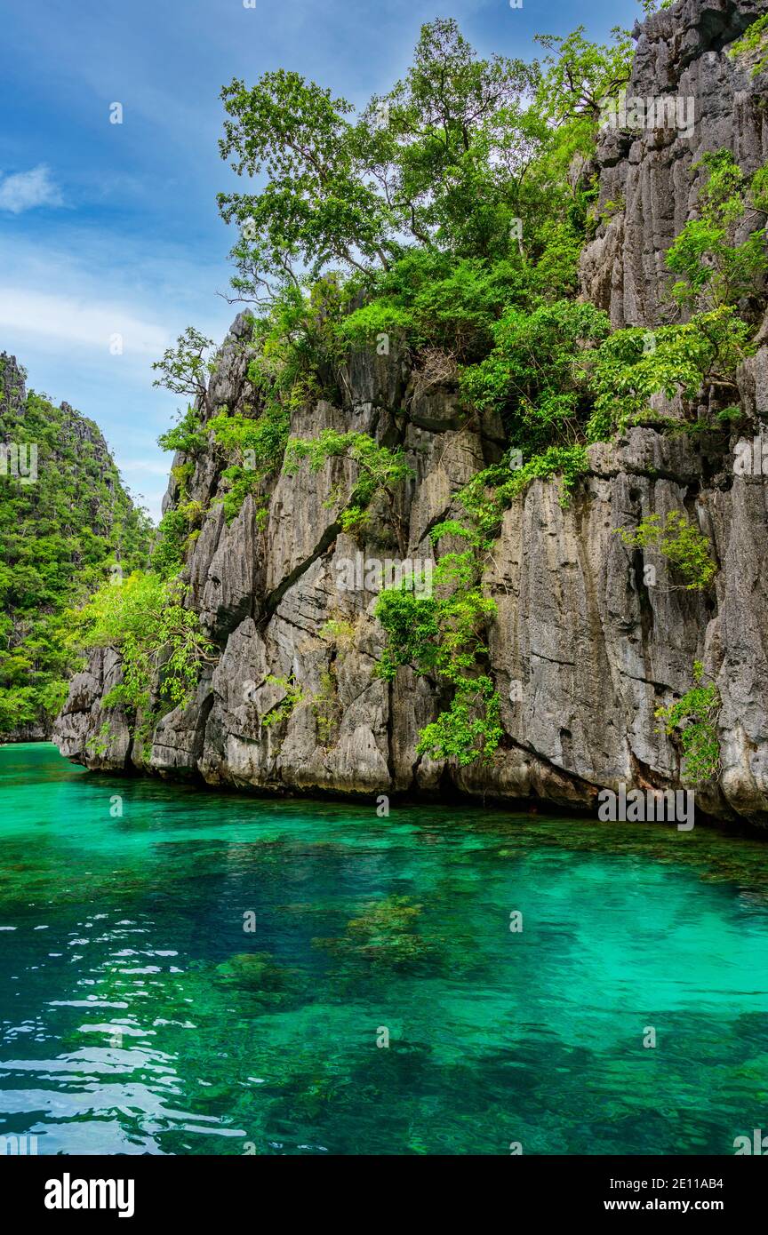 Blue crystal water in paradise Bay with boats on the wooden pier at ...