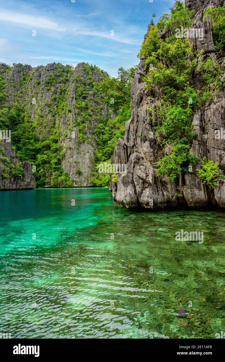 Blue crystal water in paradise Bay with boats on the wooden pier at ...