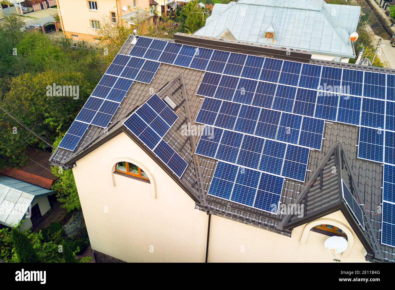Aerial view of a private house with solar photovoltaic panels for ...
