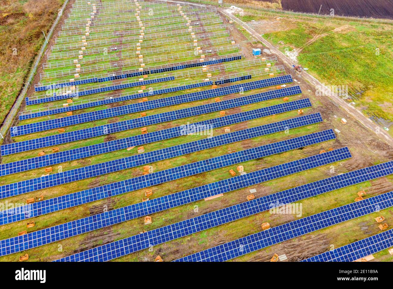 Aerial view of solar power plant under construction on green field ...