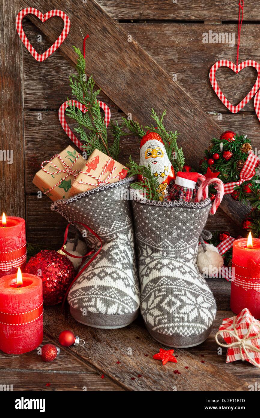 Knitted Boots With Candy And Christmas Presents Stock Photo - Alamy