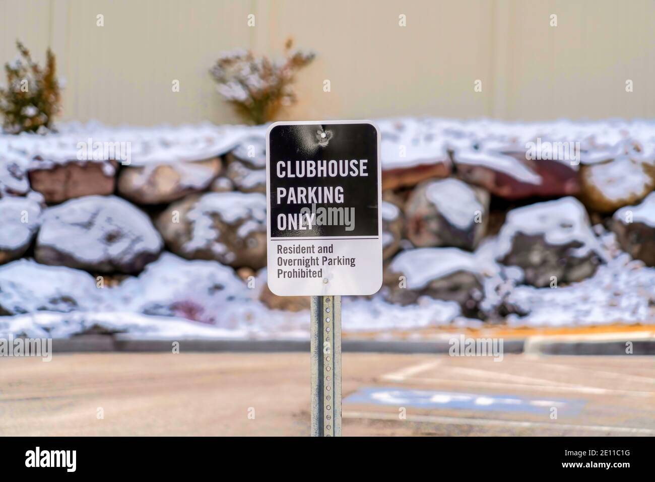 Clubhouse Parking Only signage with blurred rocky and snowy wall ...