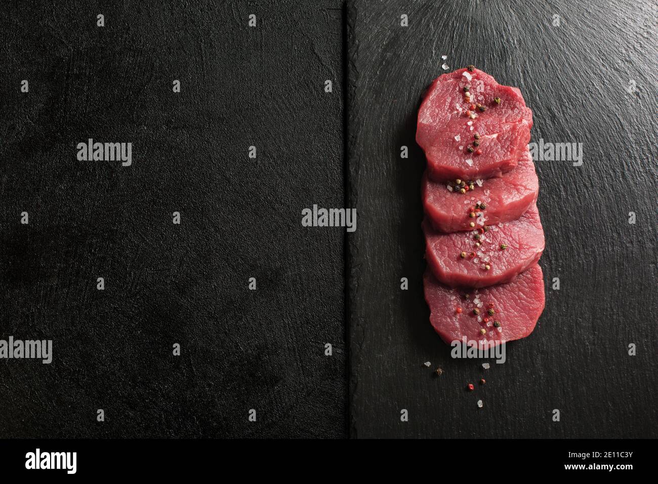 Fresh beef medallions on a kitchen cutting board. Top view. Free space ...