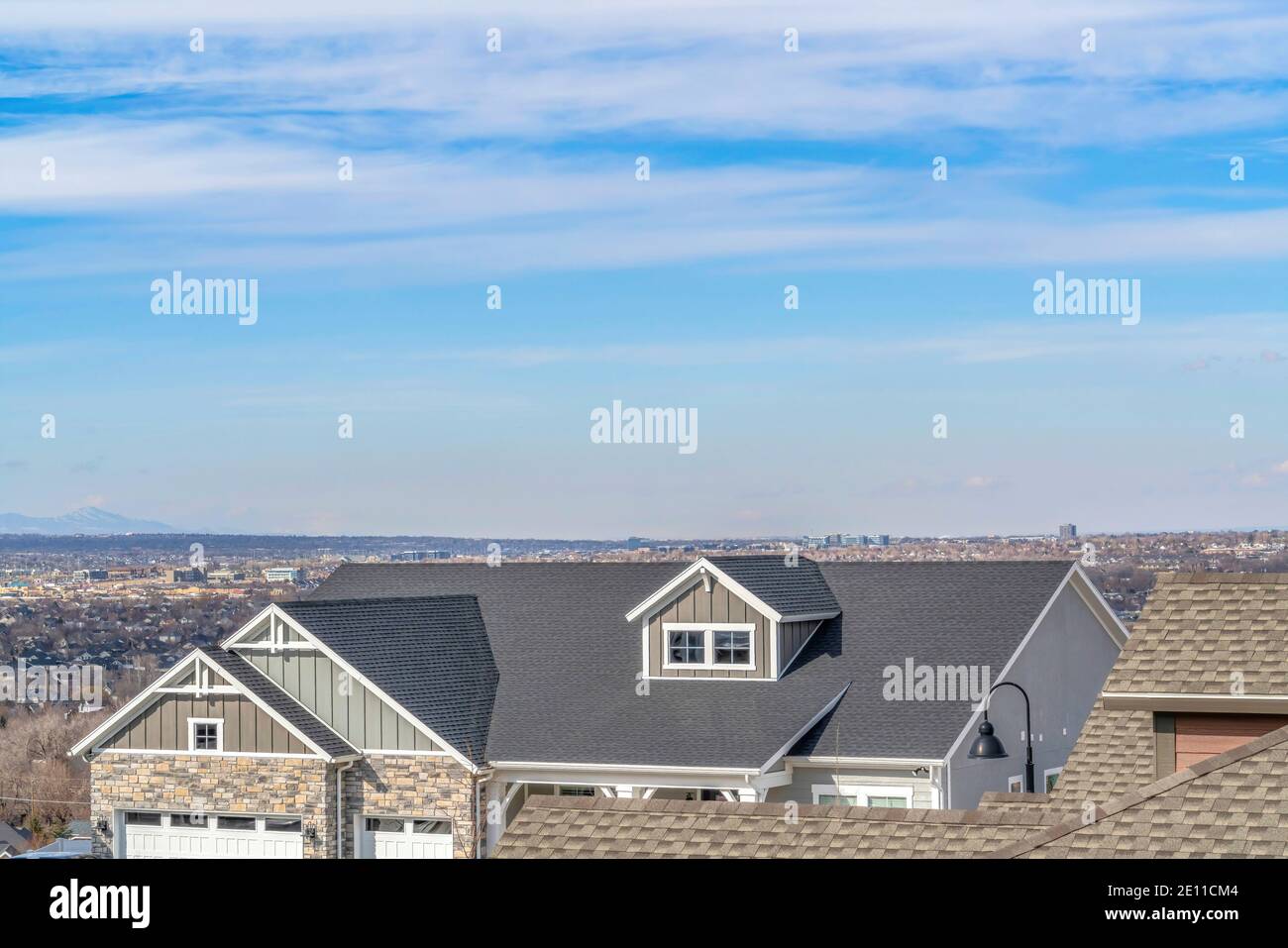 Aerial view of houses with Utah Valley landscape and cloudy blue sky ...