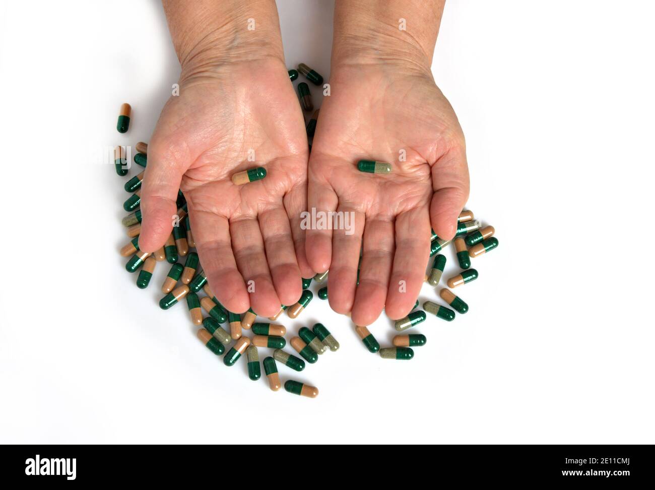 Vitamins and Supplements. Closeup of hand holding variety of green ...