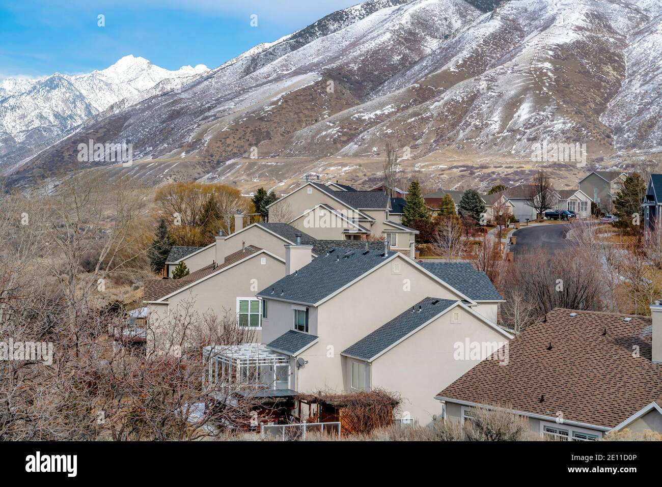 Houses on a winter neighborhood landscape with snowy mountain slope ...