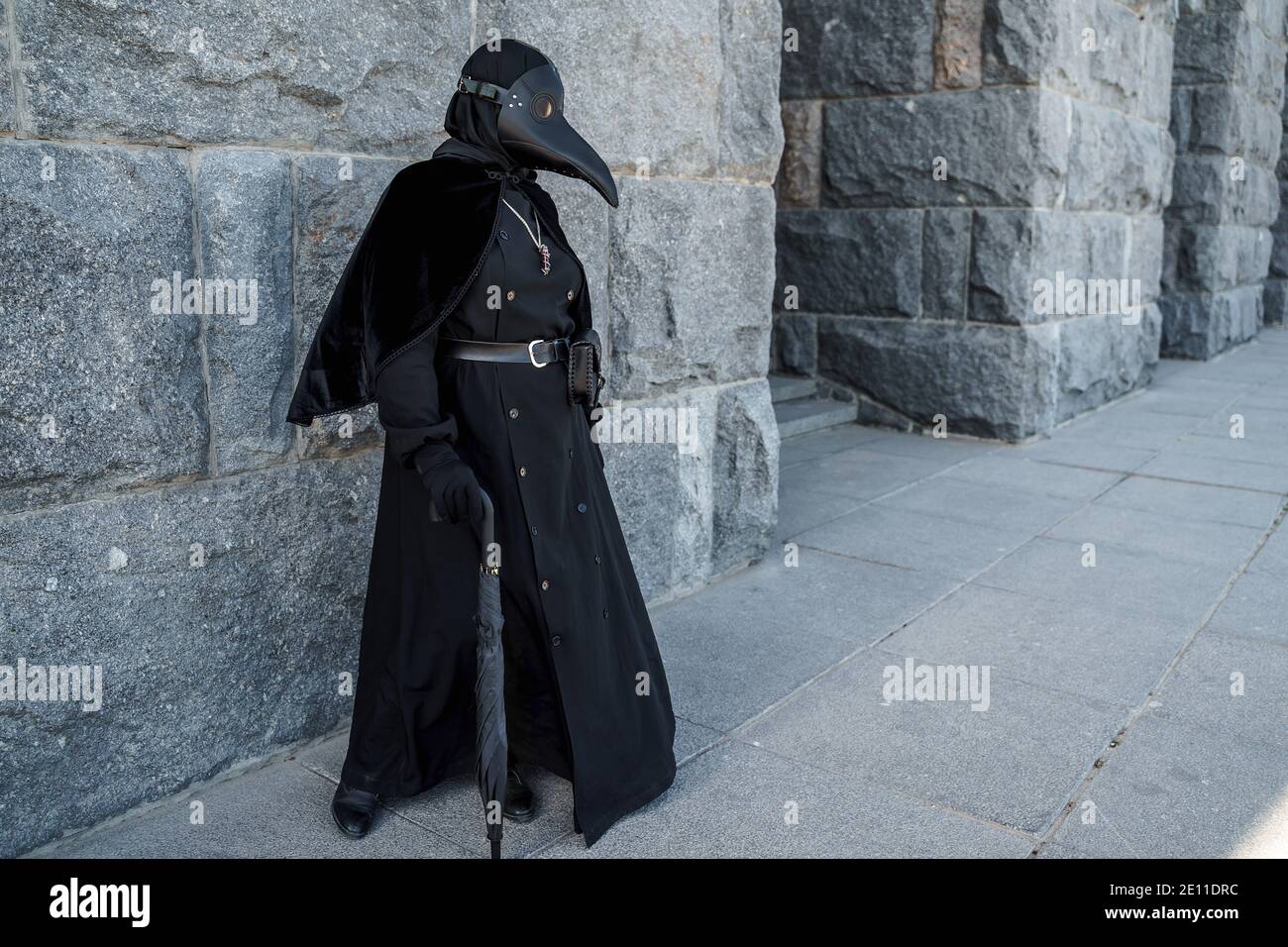 plague doctor stands against a stone wall Stock Photo - Alamy