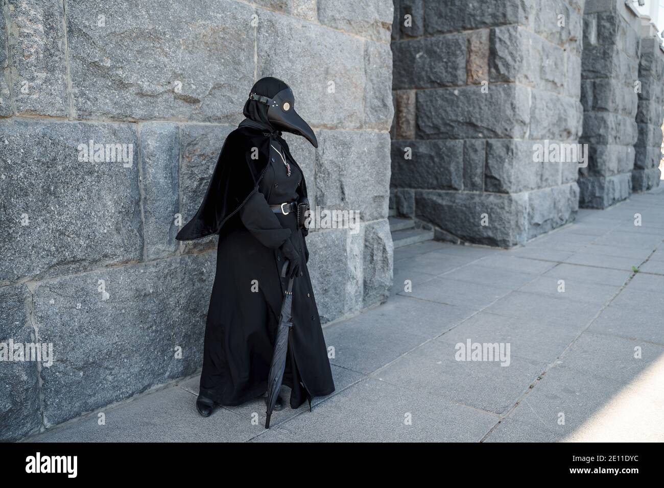 plague doctor stands against a stone wall Stock Photo - Alamy