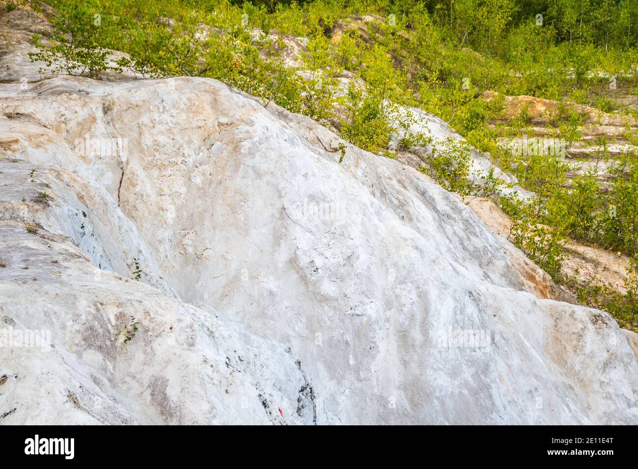 Abandoned talc quarry overgrown with trees and grass Stock Photo - Alamy