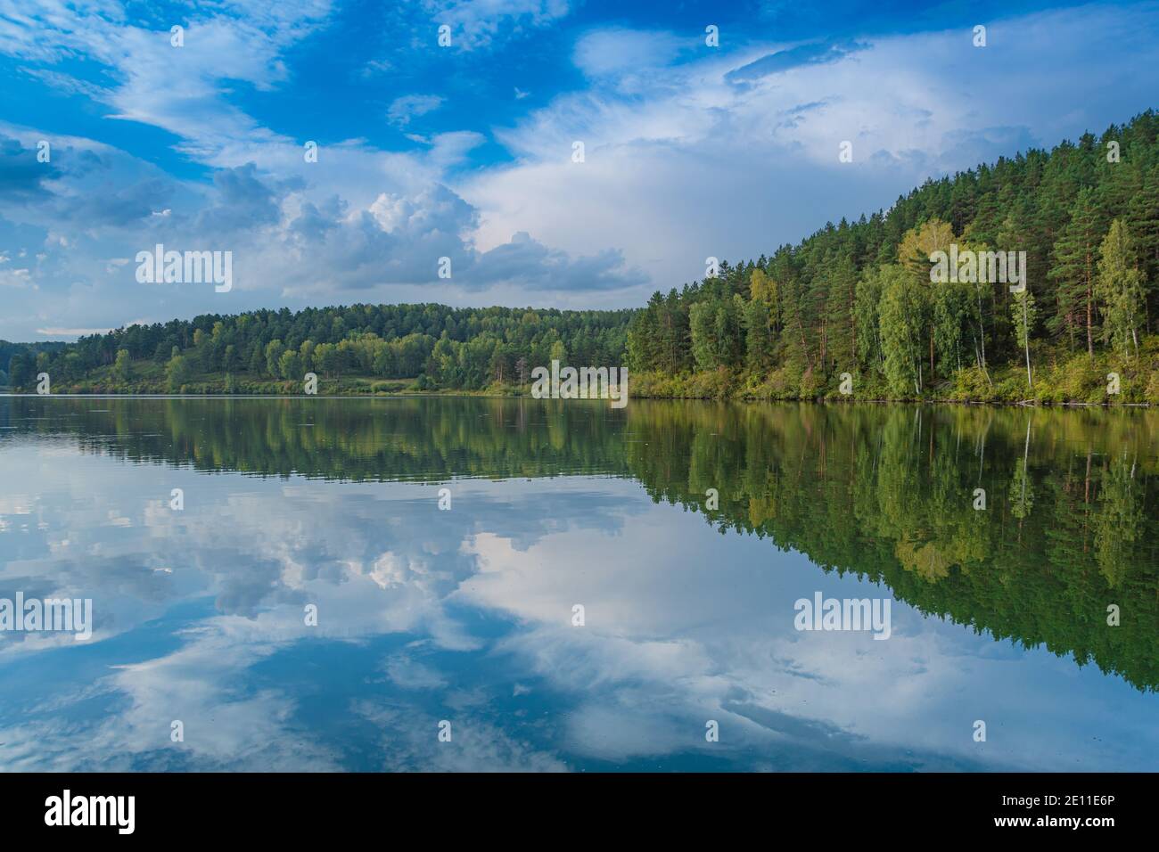 Reflection of trees in mirror of lake Stock Photo - Alamy
