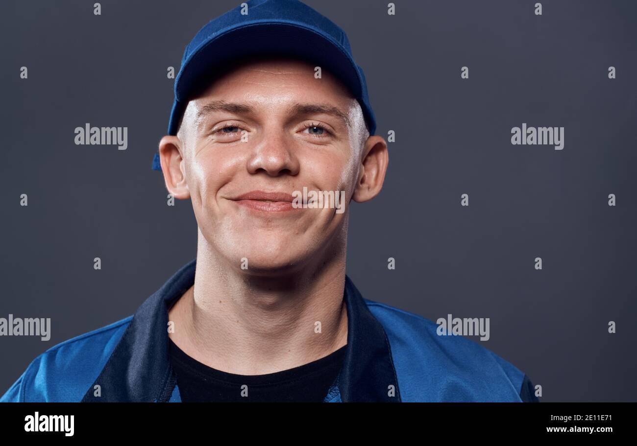 man in work uniform blue cap cropped view work service Stock Photo - Alamy