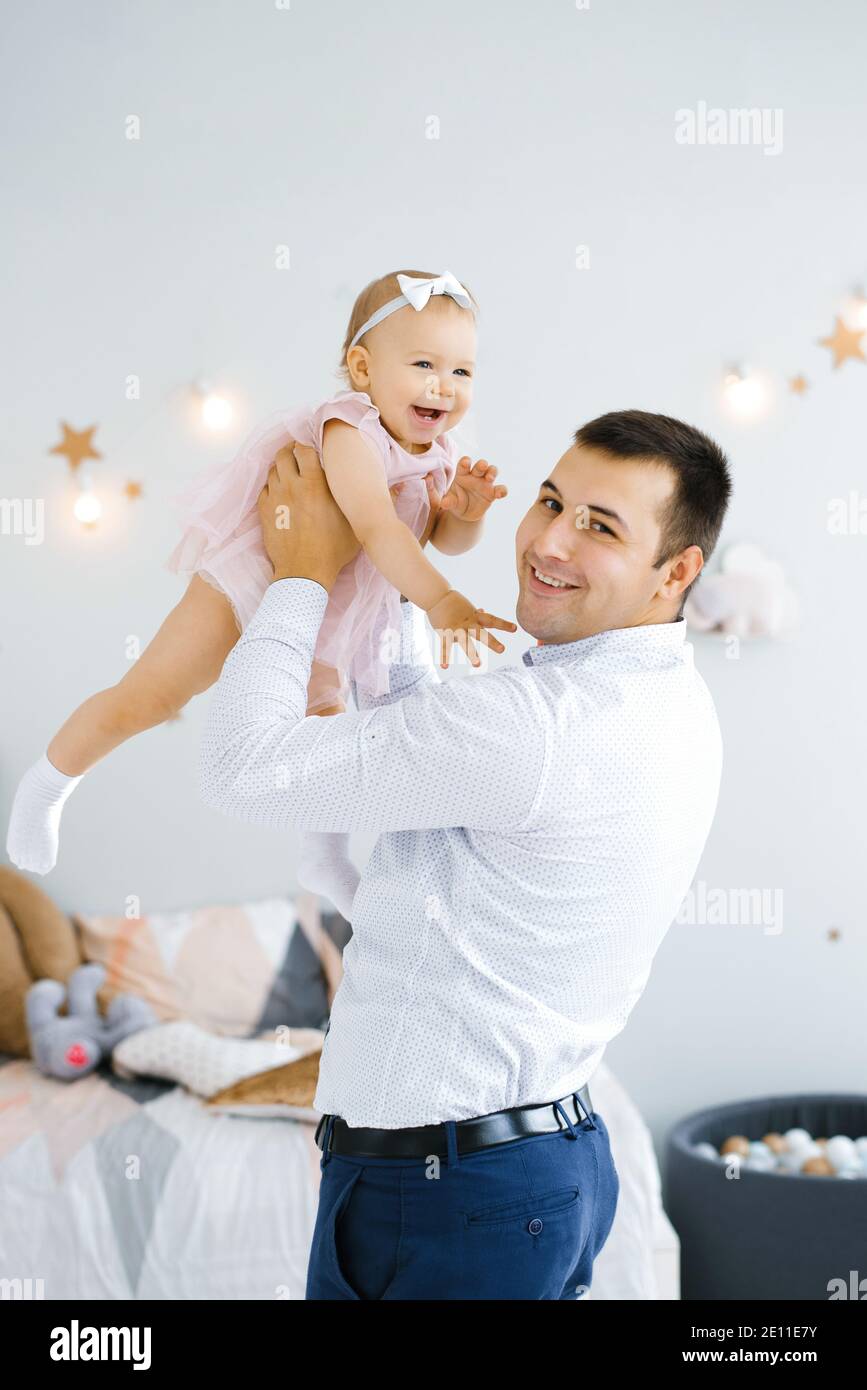 Father lifting baby girl. Happy father picks up and throws his lifting ...
