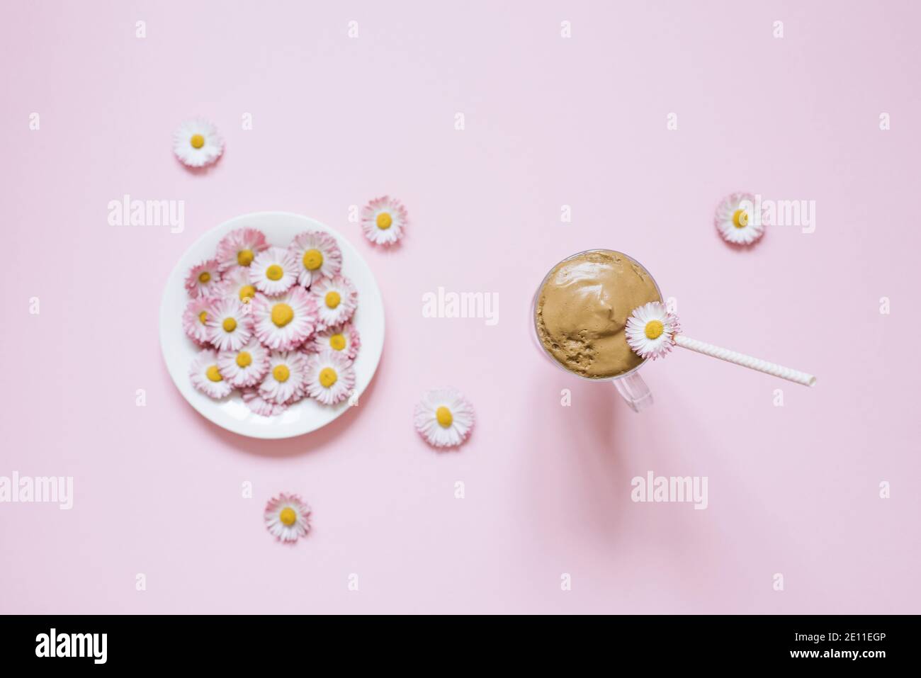 dalgona Coffee in a transparent Cup with a paper tube, a plate with ...