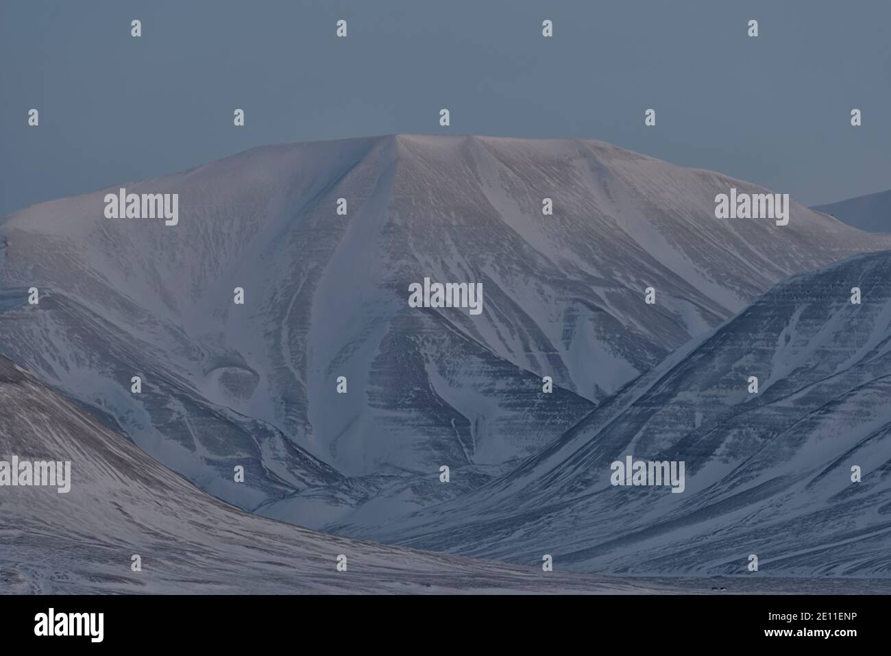 Dark winter season on Svalbard. Twilight on the mountains in ...
