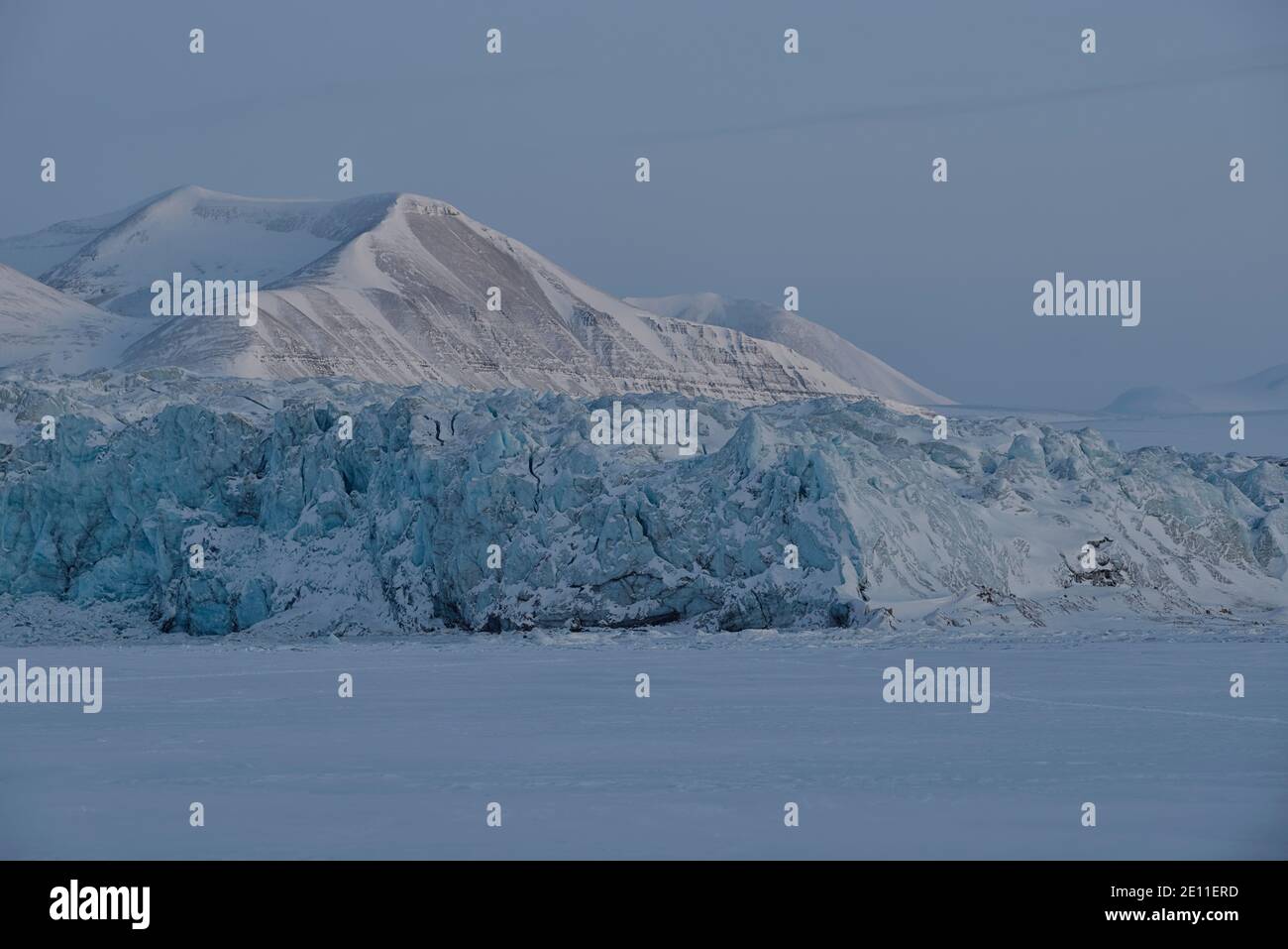 Dark winter season on Svalbard. Glacier Tunabreen and mountains in ...