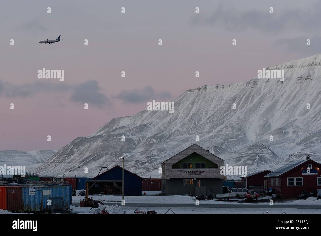 Dark winter season on Svalbard. Mountains and houses in the twilight in ...